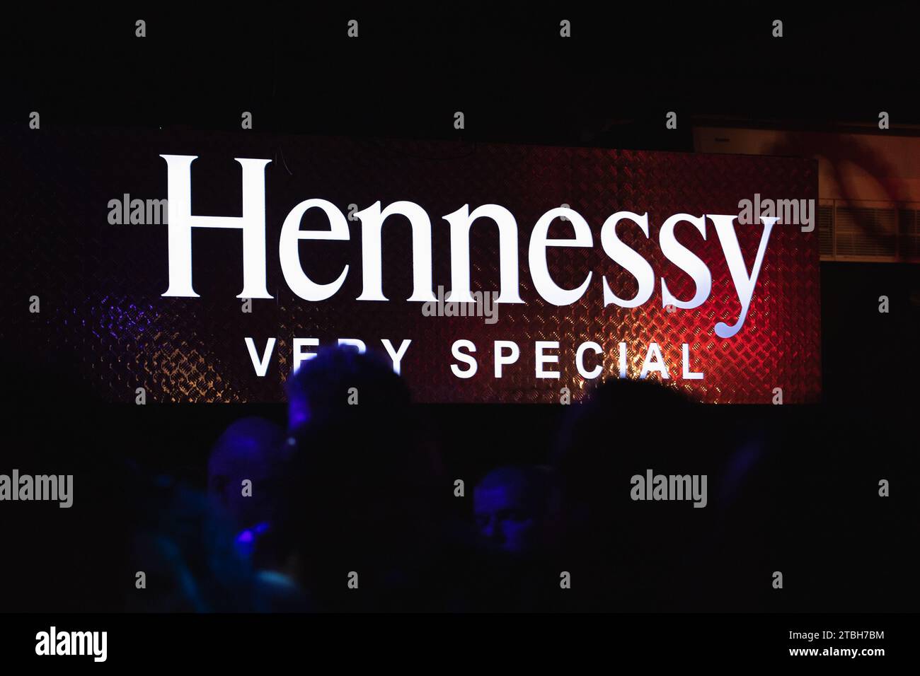 Illuminated advertising box with the Hennessy logo on the wall in a ...