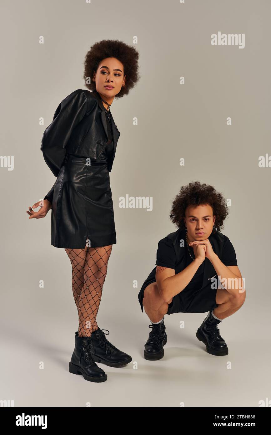 young african american brother and sister in trendy black outfit posing ...