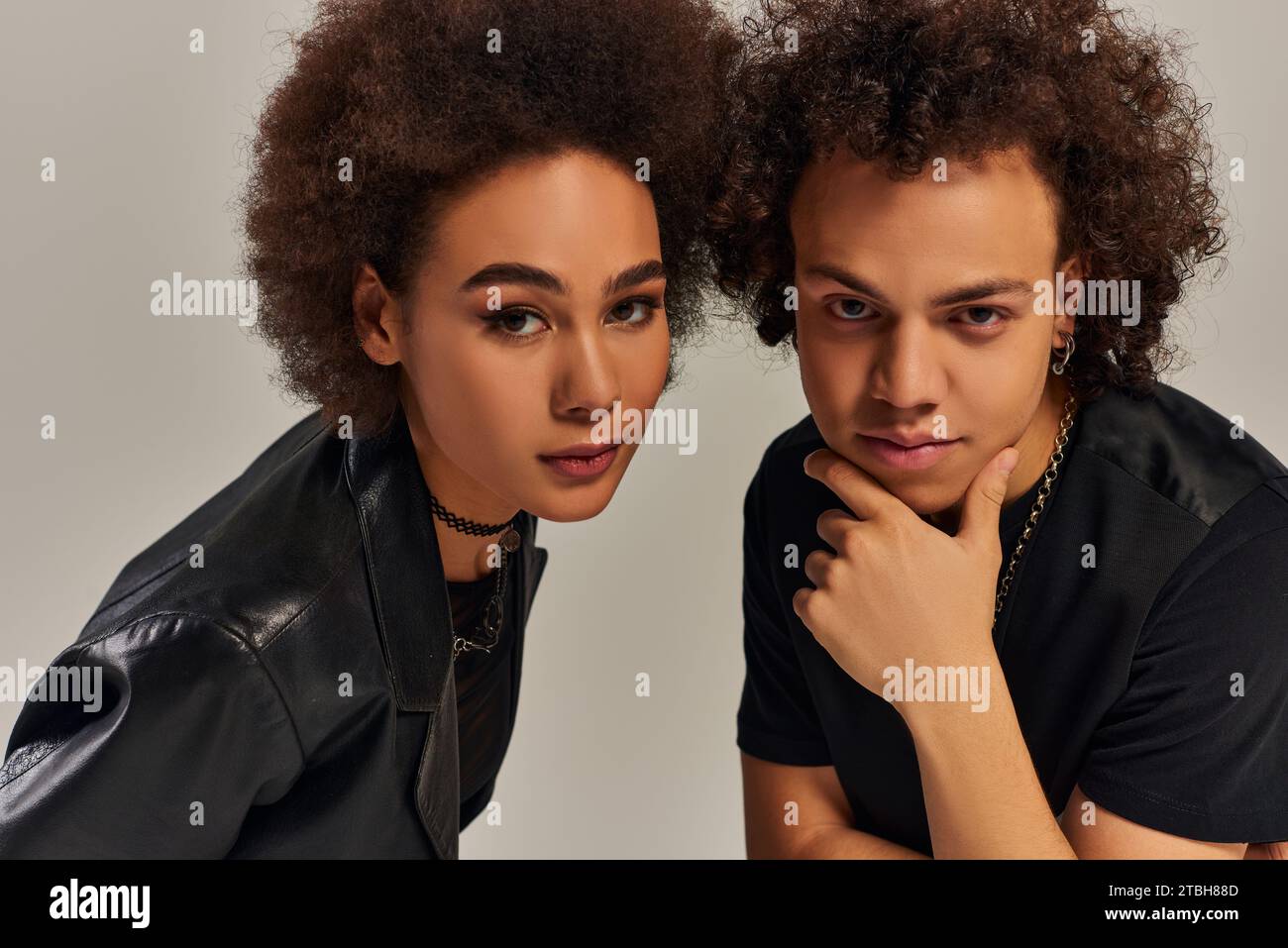 portrait of stylish african american siblings in urban outfits posing ...