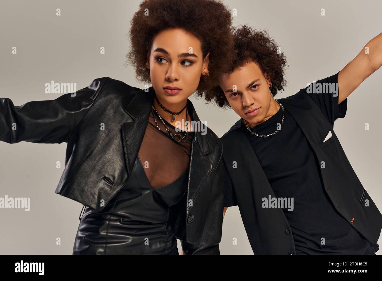 fashionable african american siblings in urban stylish outfits posing ...