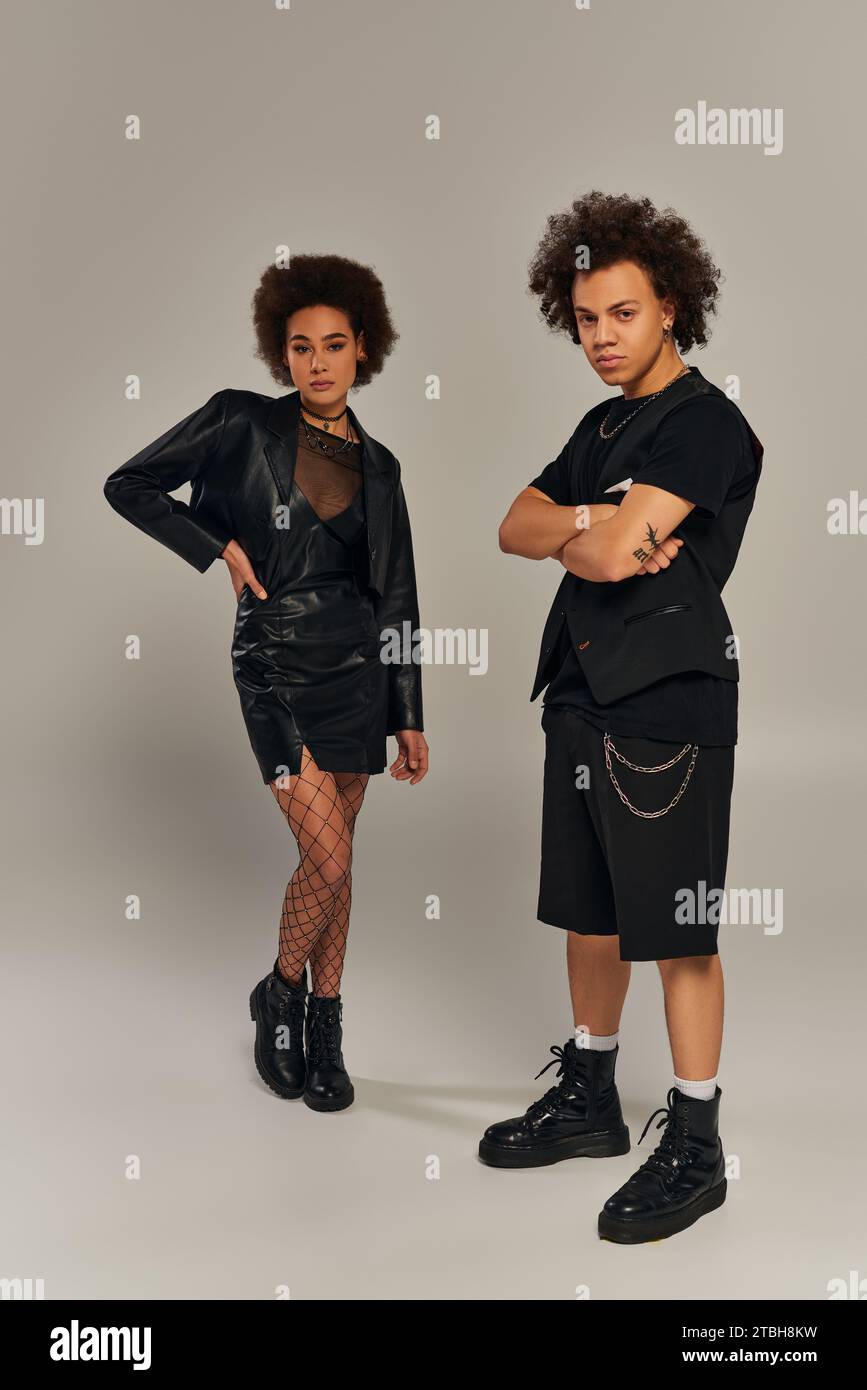 trendy young african american siblings in stylish urban attire posing ...