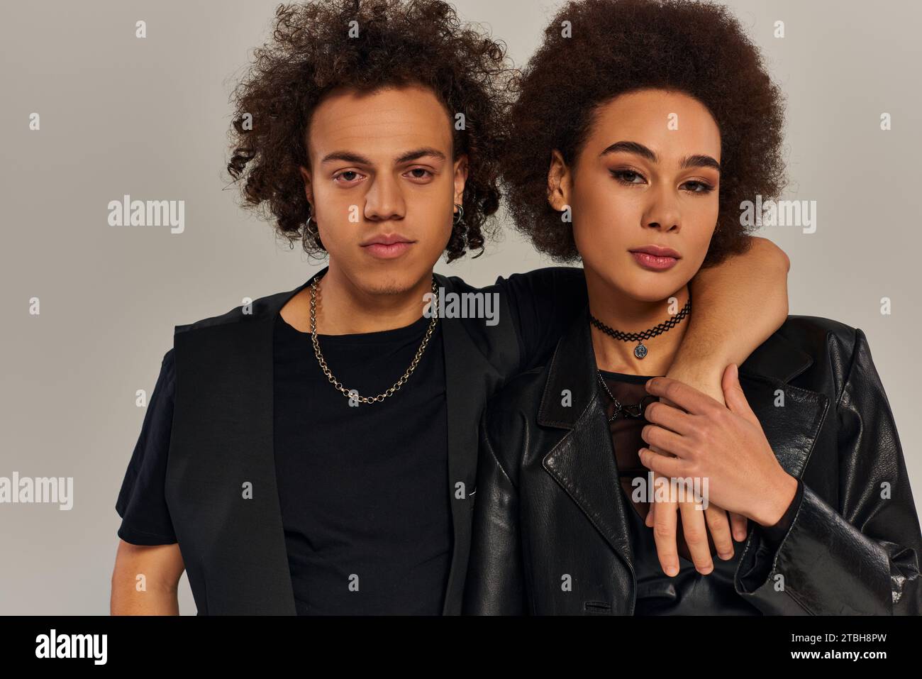 good looking trendy african american siblings in black outfits hugging ...