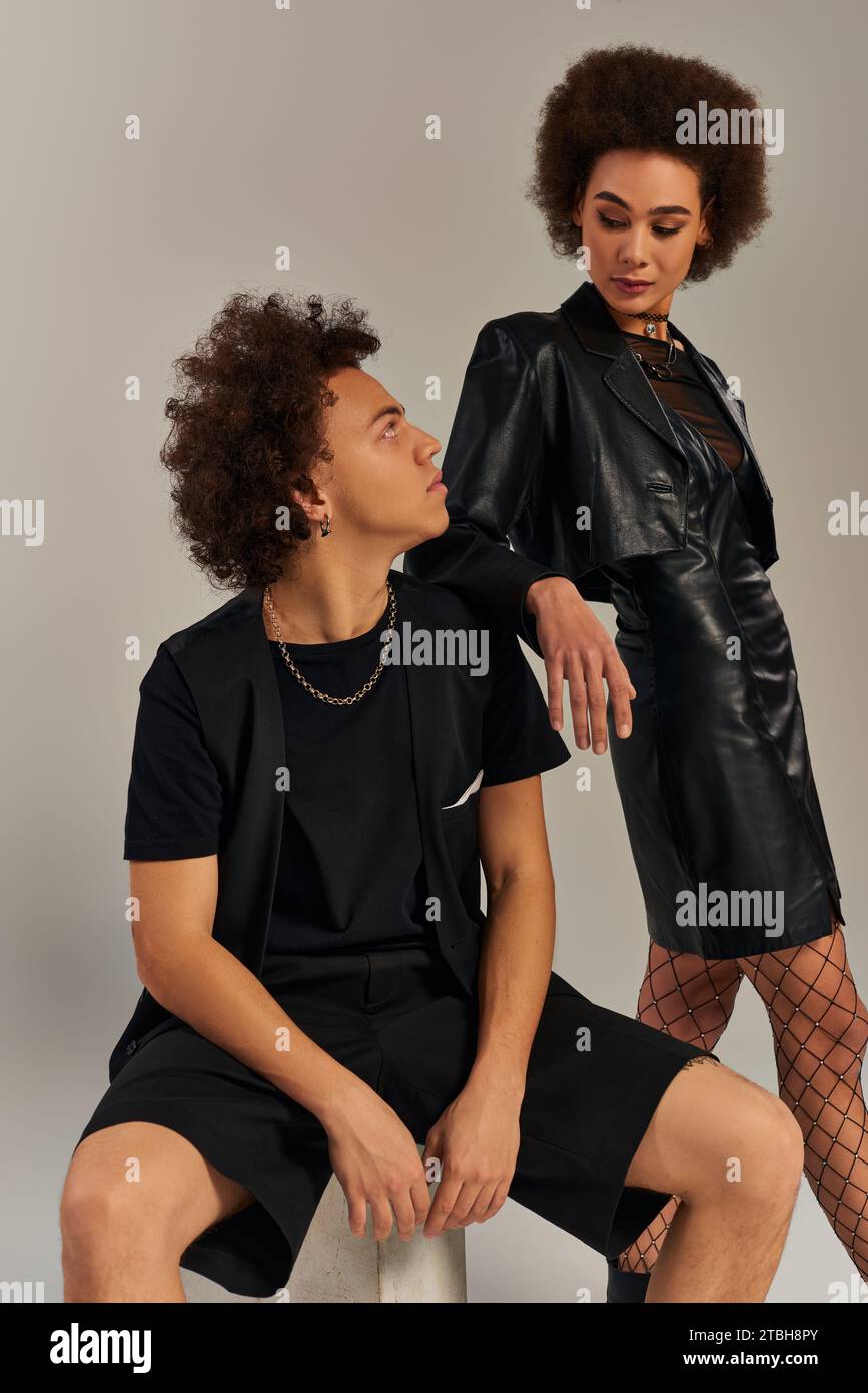 young fashionable african american siblings posing together on gray ...