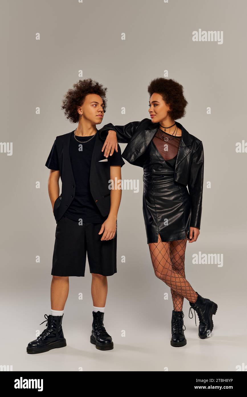 attractive smiling african american siblings in fashionable black ...