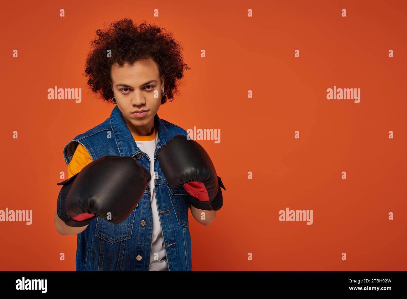 good looking sporty african american man posing lively in boxing gloves ...