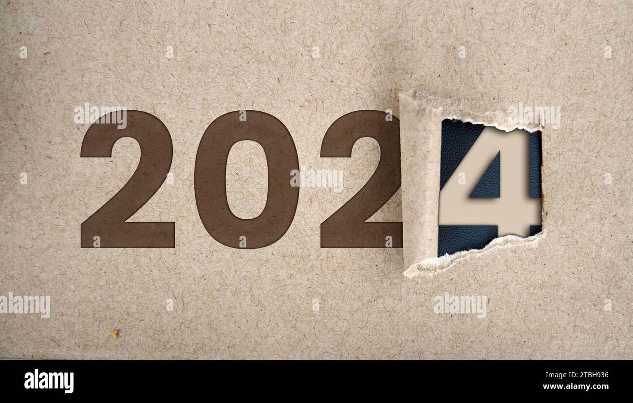 Number of 2024 inside of pink hole of torn paper Stock Photo - Alamy