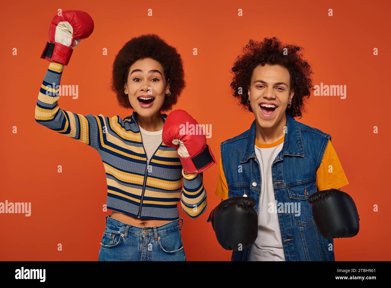 cheerful african american siblings in boxing gloves having fun together ...