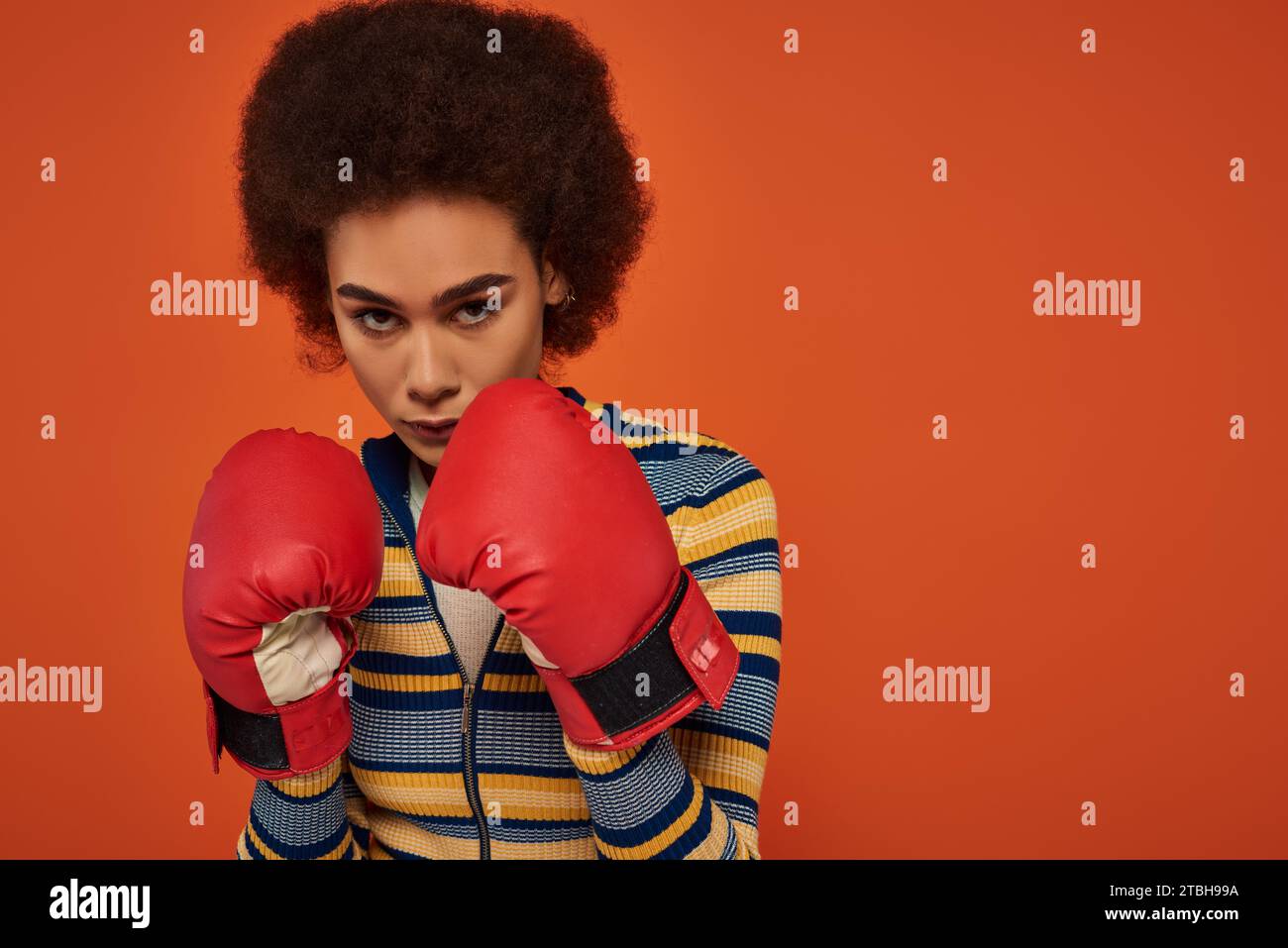 beautiful focused african american woman posing actively with boxing ...