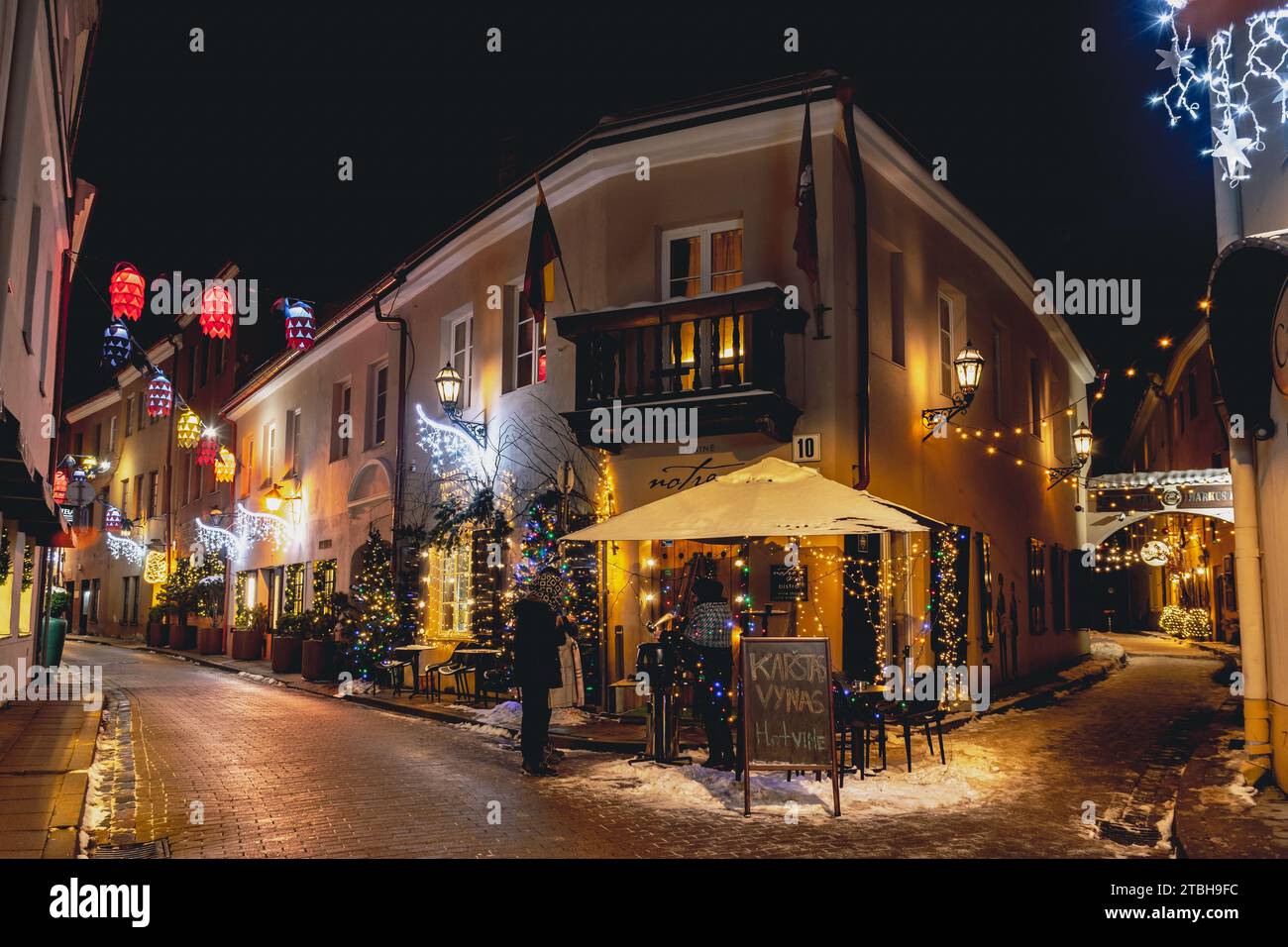 Beautiful street view with cozy Christmas decorations, wreath, garlands ...