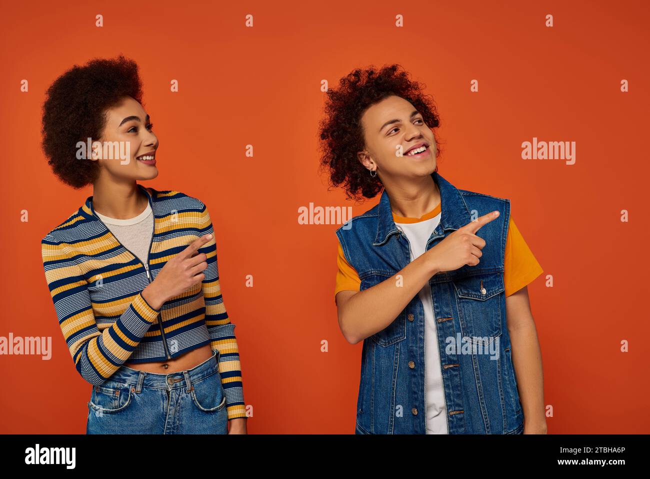 young african american brother and sister gesturing and smiling happily ...