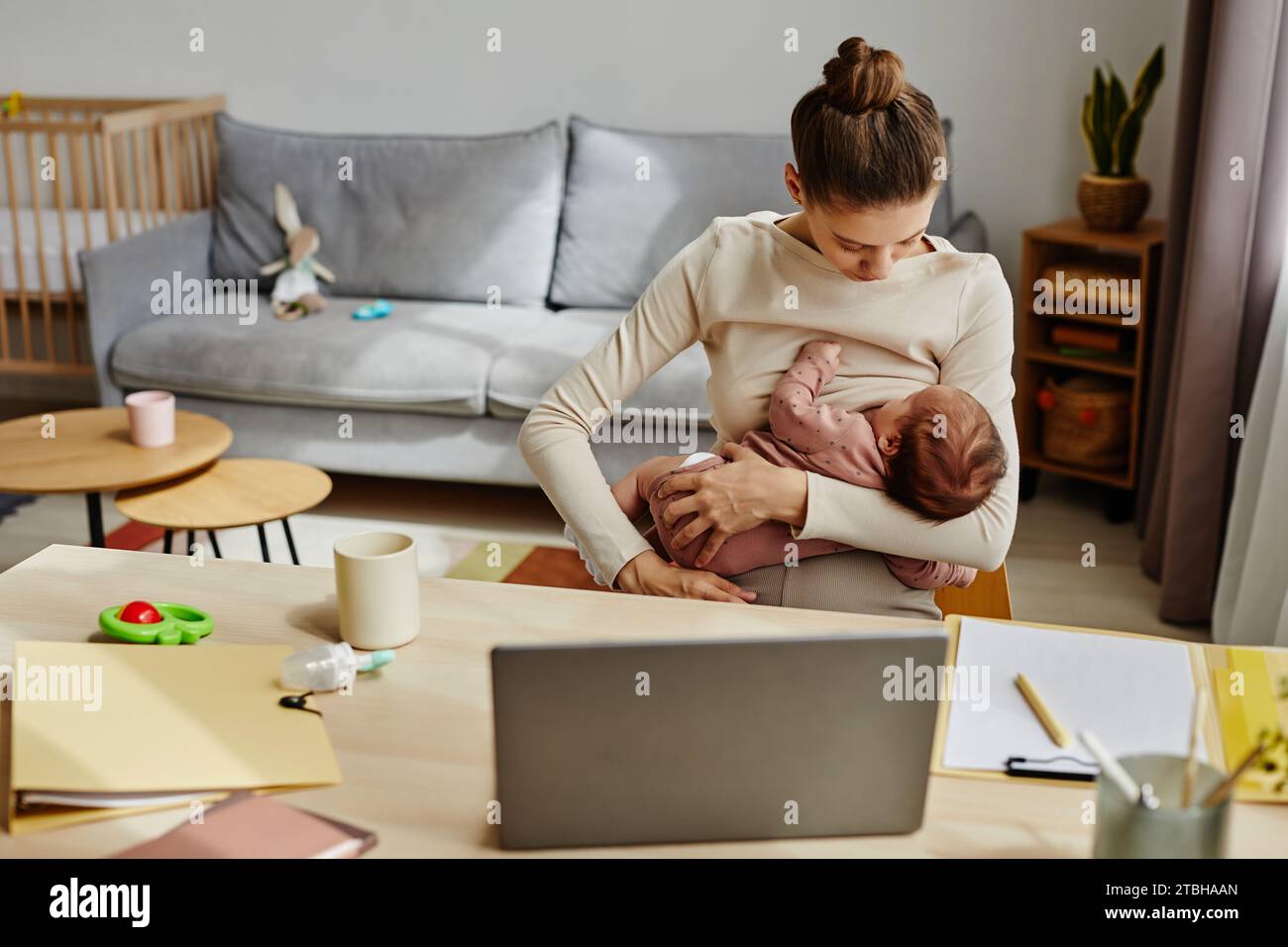 Mother Breastfeeding Infant during Work Time Stock Photo - Alamy