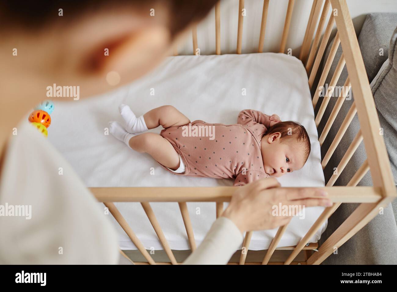 Mother Watching Her Baby Stock Photo - Alamy