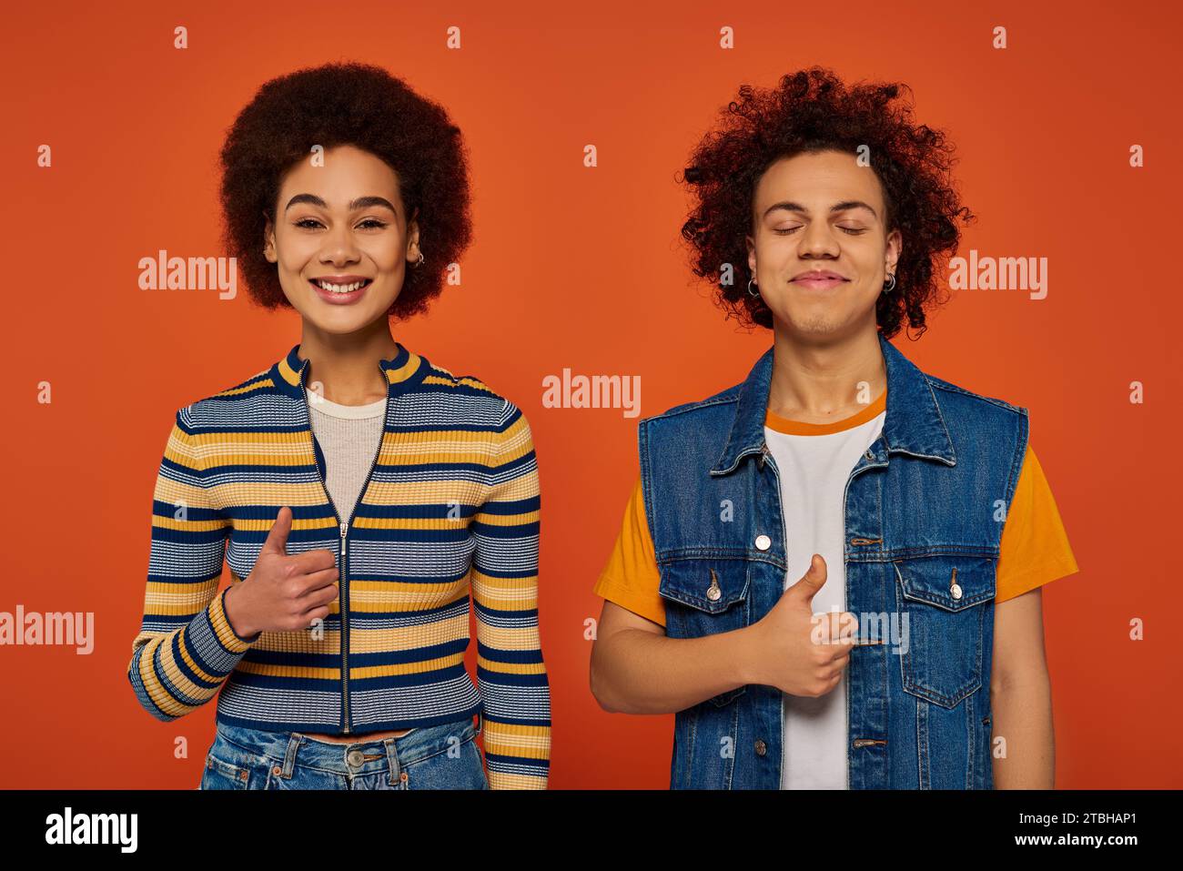 cheerful african american siblings in vibrant outfits posing together ...