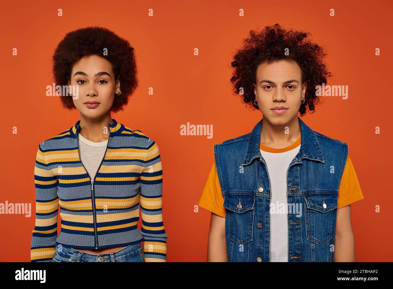 emotional african american siblings in vibrant attires posing together ...
