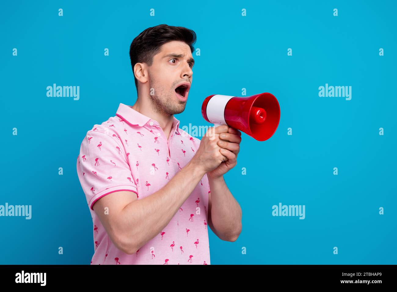 Profile portrait of speechless unsatisfied young man hold loudspeaker ...
