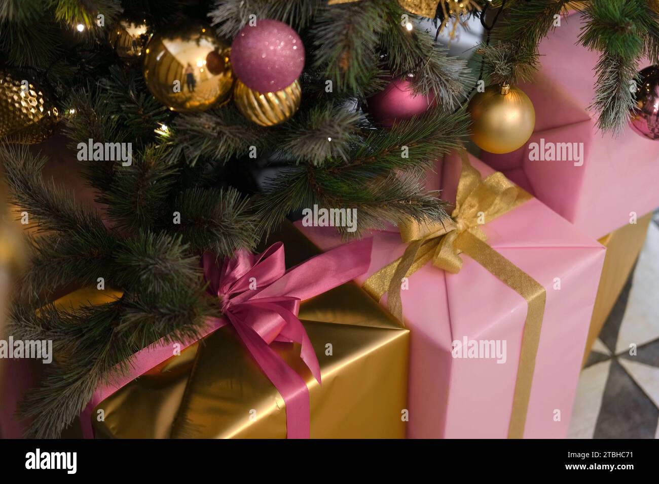 Big Wrapped Gift Boxes Is Under the Christmas Tree. Pink and Gold Gift ...