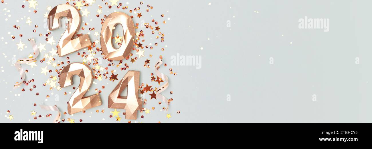 Banner with 2024 golden numbers, ribbons and stars confetti on a blue ...