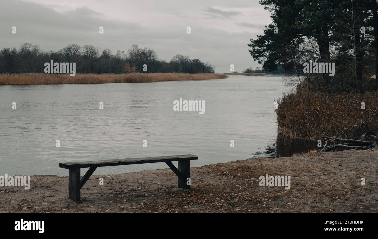 lonely bench with river view Stock Photo - Alamy