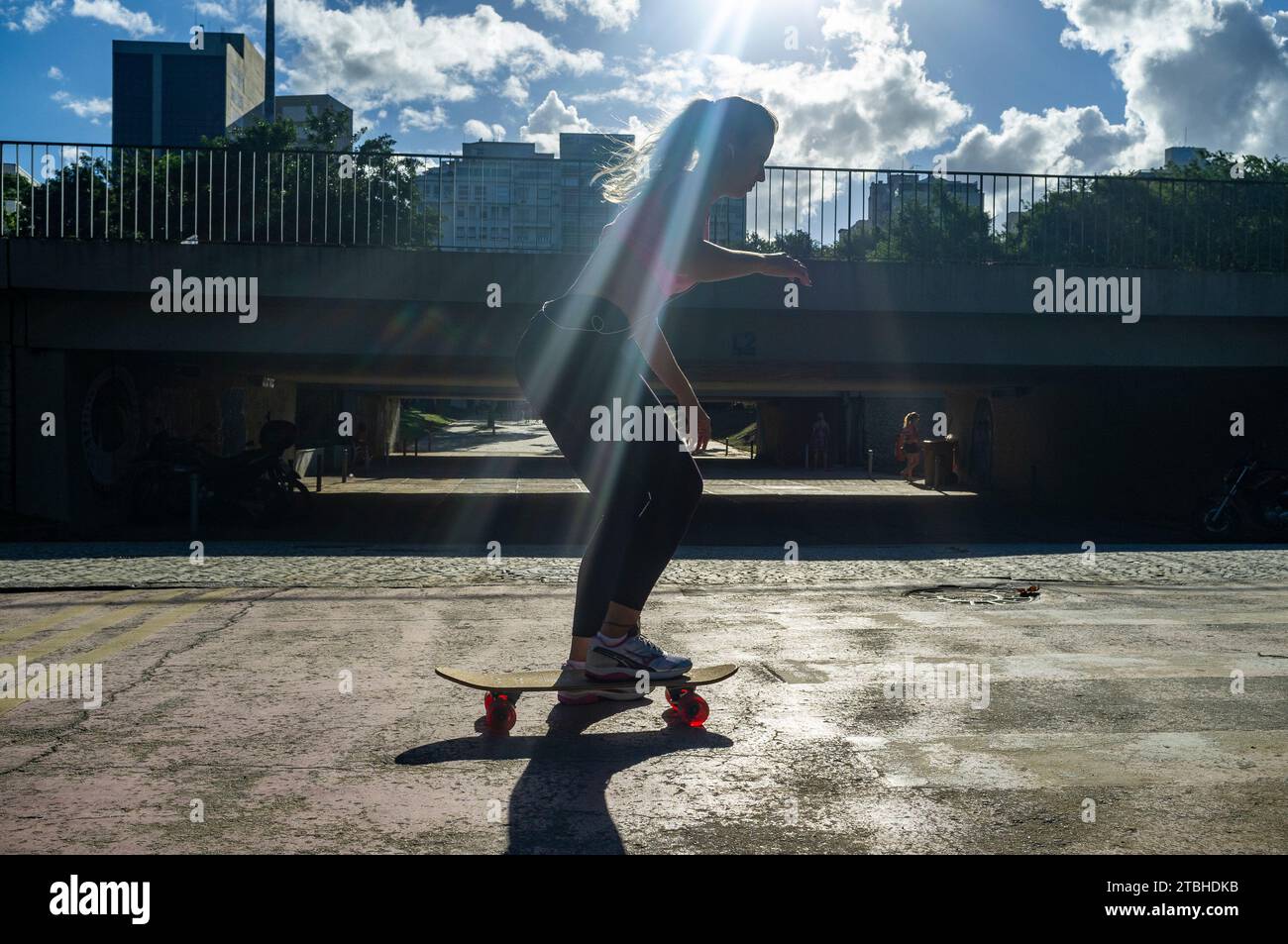 Outdoor recreation, young woman skateboarding in Flamengo park, Rio de ...