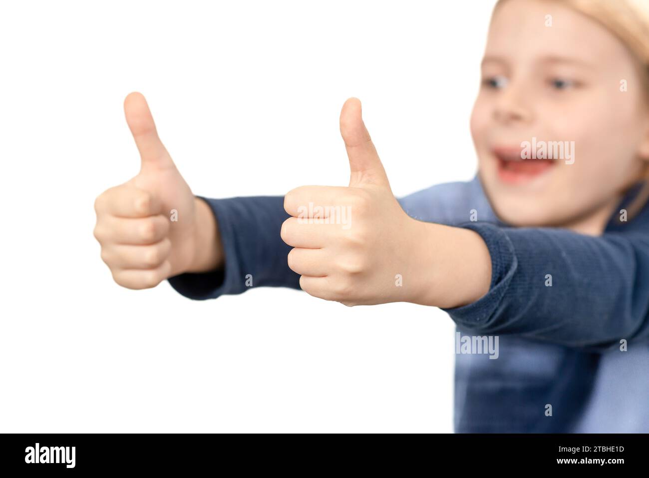 Child's hands making the thumbs-up sign, a gesture of endorsement and ...
