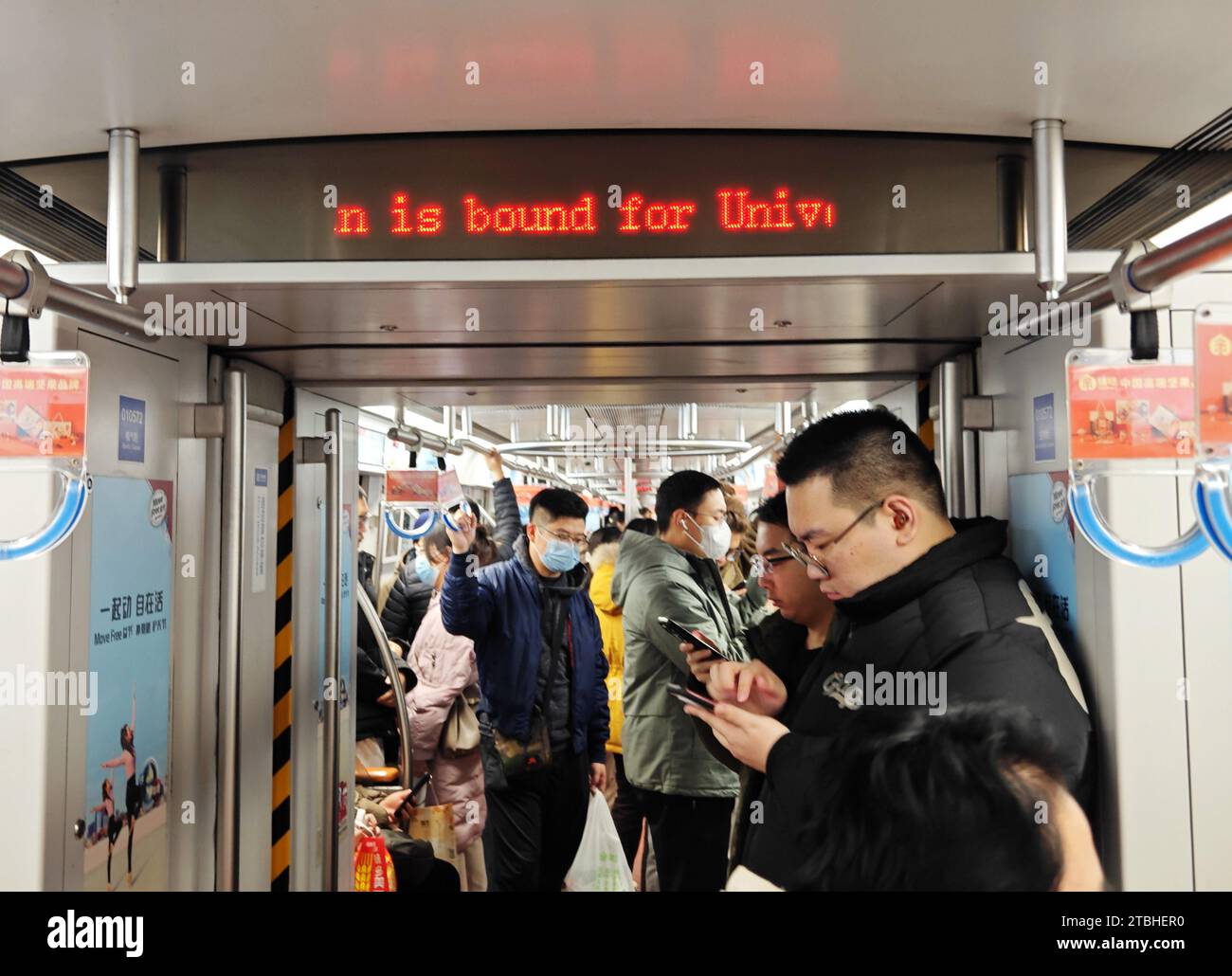 BEIJING, CHINA - DECEMBER 7, 2023 - Passengers wait under a bilingual ...