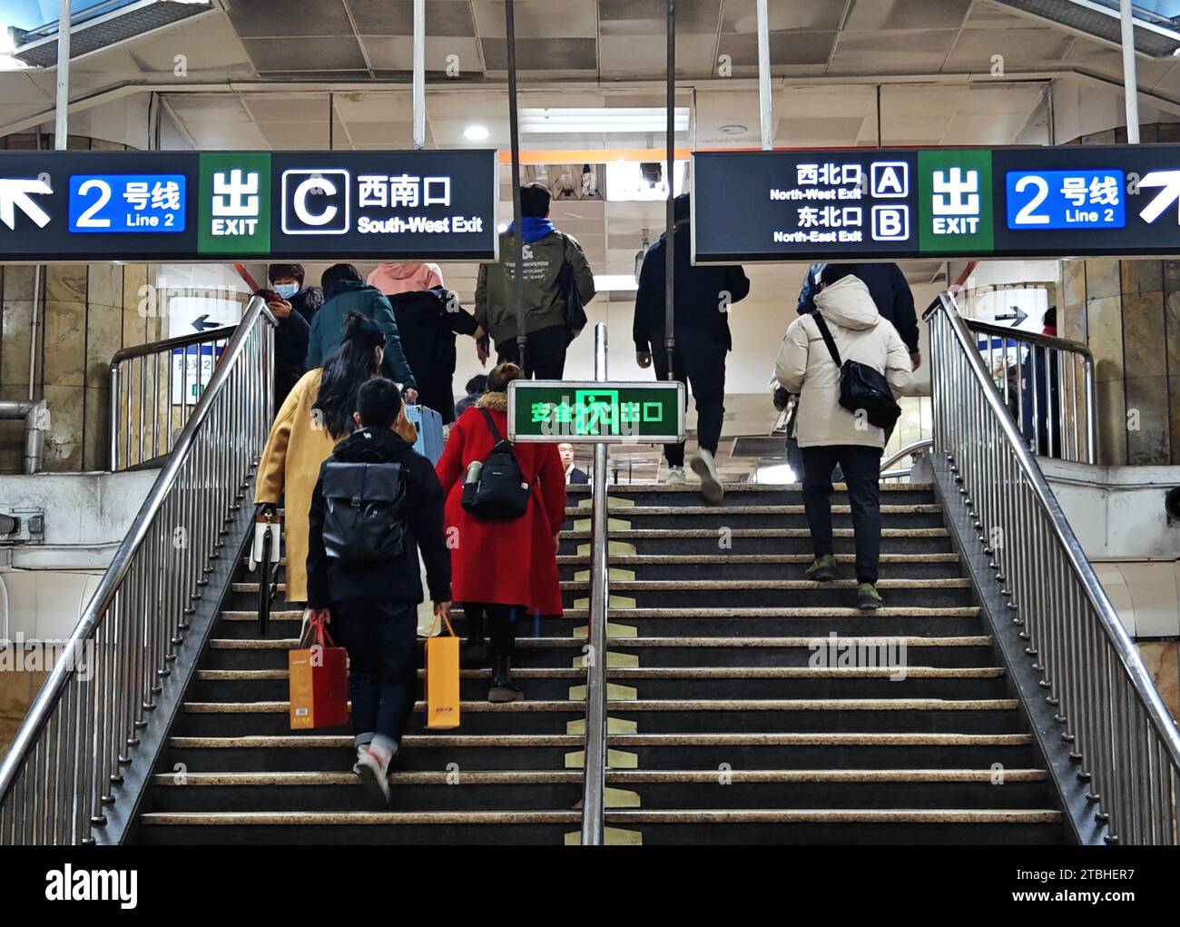 BEIJING, CHINA - DECEMBER 7, 2023 - Passengers wait under a bilingual ...