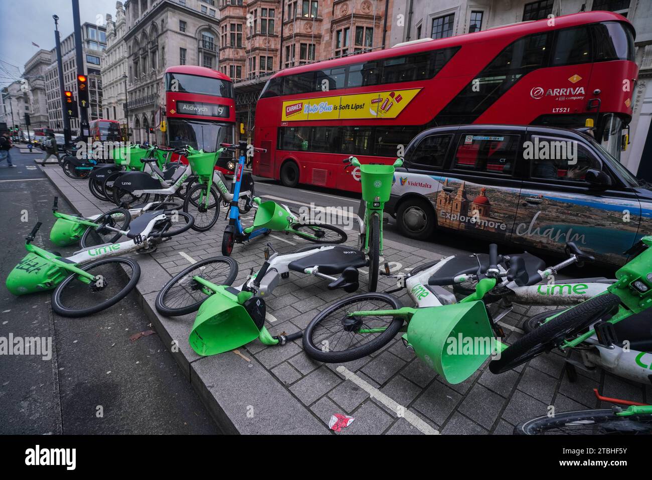London UK. 7 December 2023. Discarded Lime Rental e-bike spill onto Piccadilly street parking ...