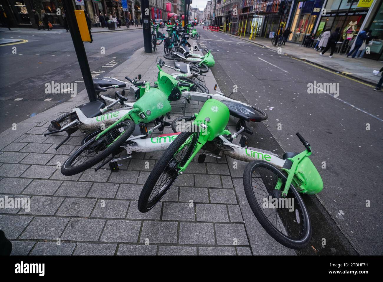 London UK. 7 December 2023. Discarded Lime Rental e-bike spill onto Piccadilly street parking ...