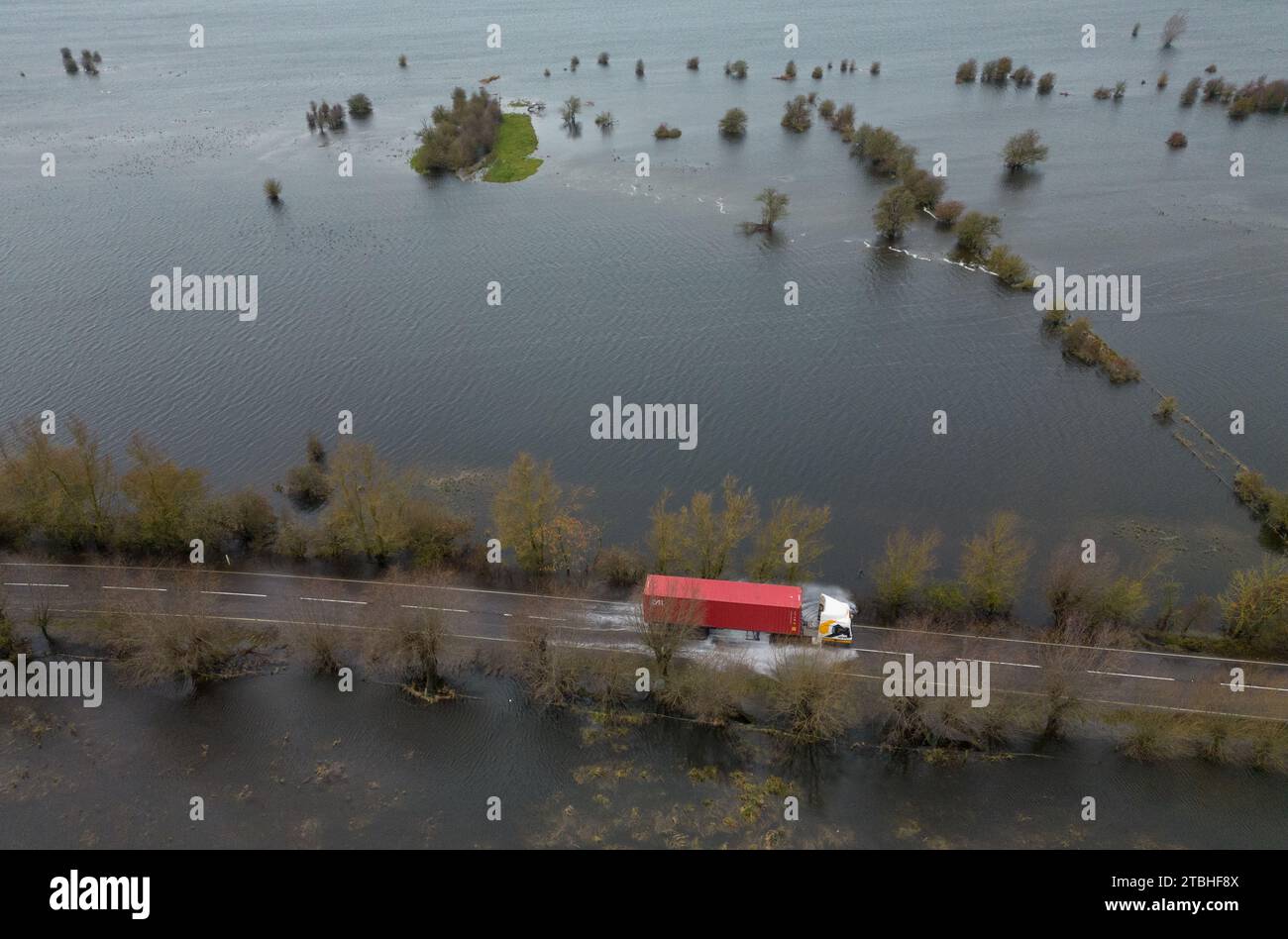 A lorry drives through surface water on the A1101 in Welney in Norfolk ...