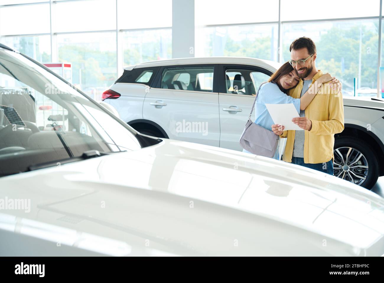 Photo of loving couple in car dealership Stock Photo - Alamy