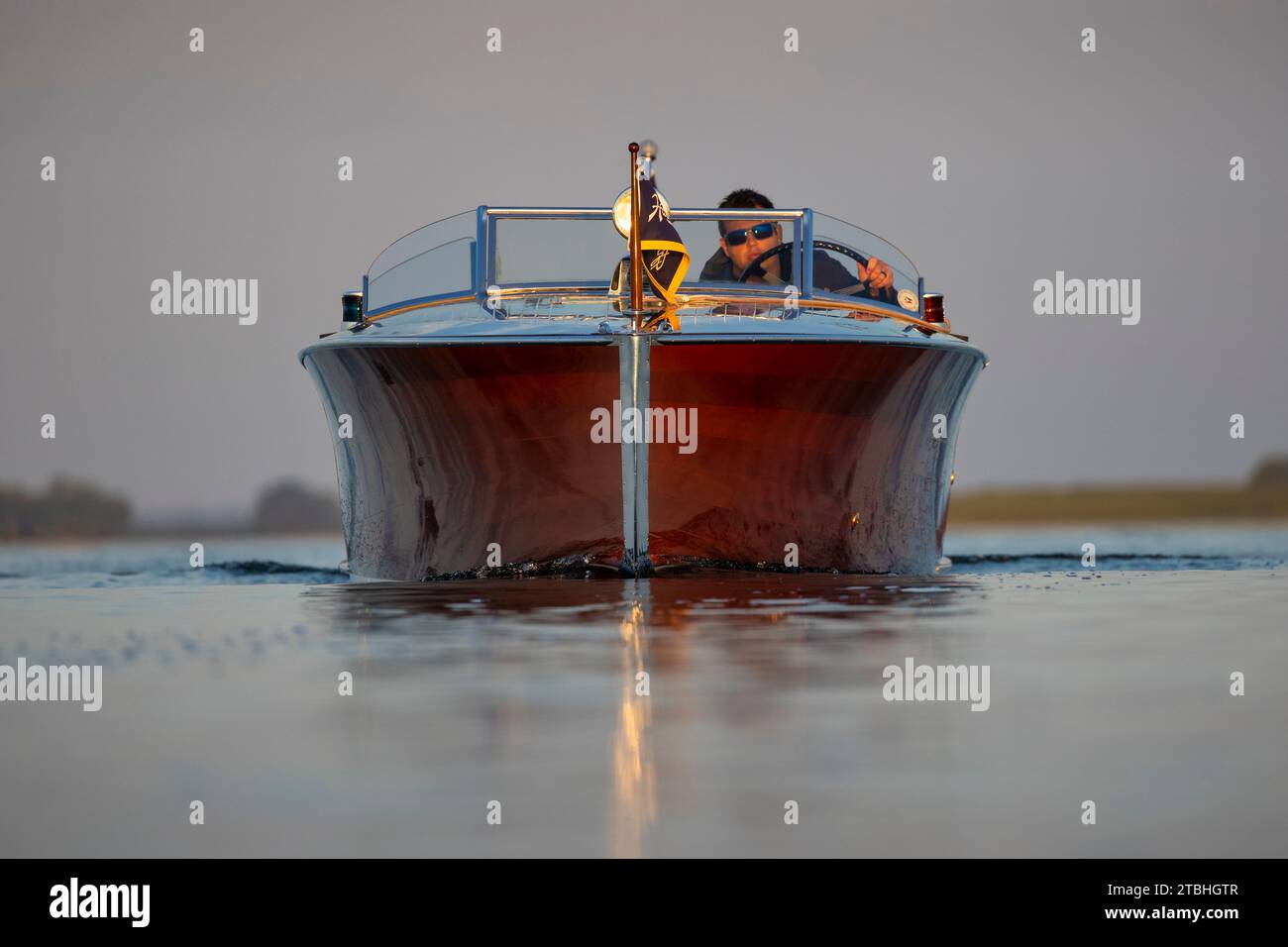 A vintage wooden speedboat approaching head-on at slow speed Stock ...