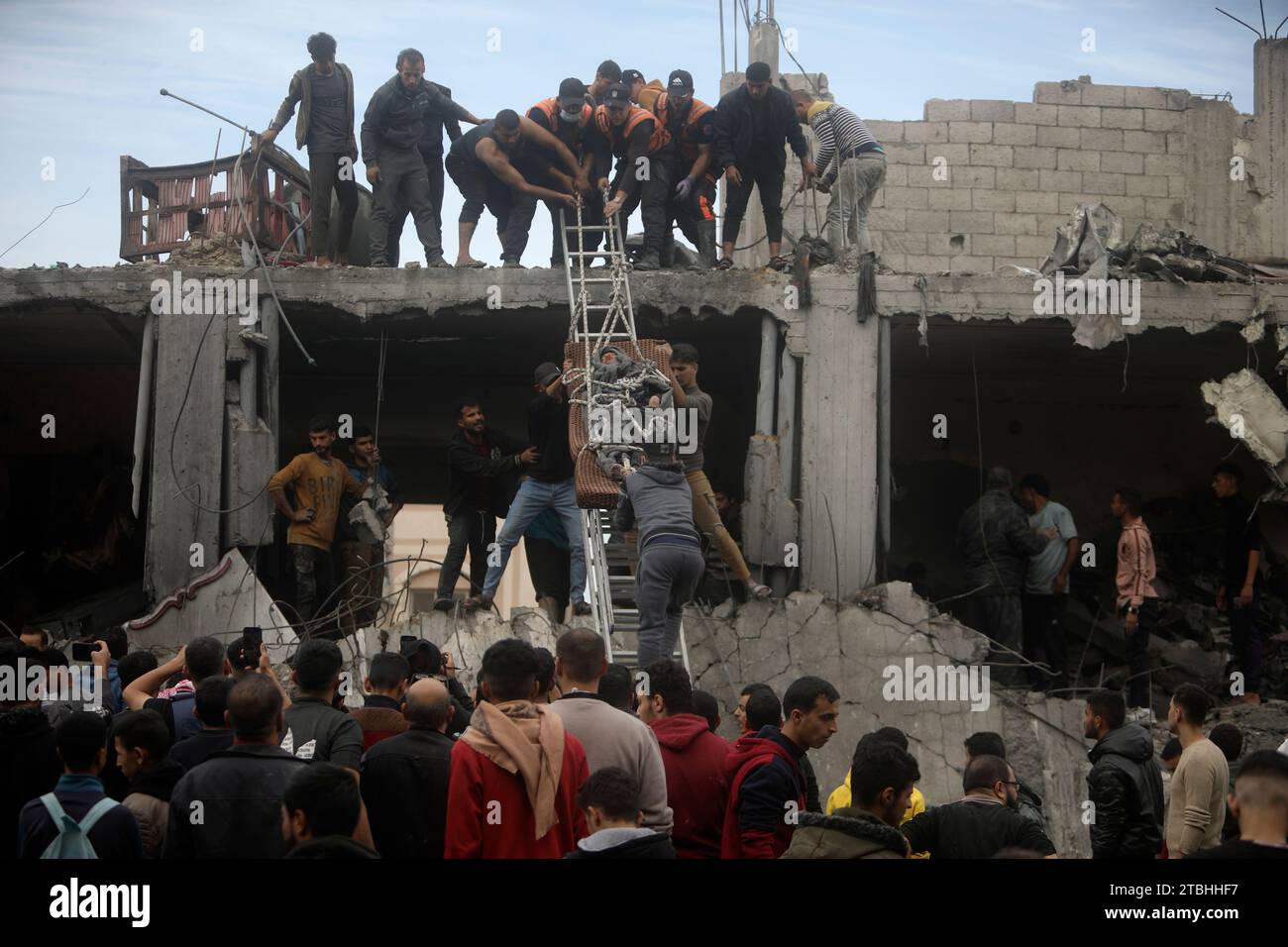Palestinians rescue a man from a destroyed building following Israeli ...