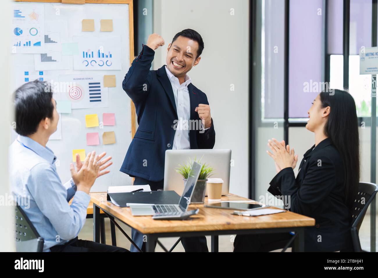 Man professional celebrate with colleague in conference room. Group of ...