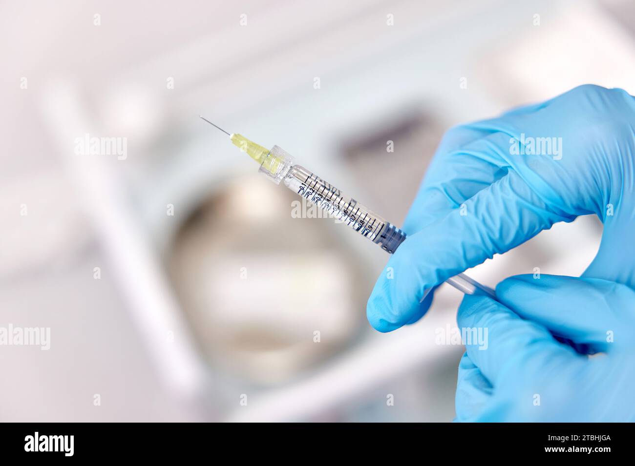 Physician hand in blue gloves with syringe for injection Stock Photo ...