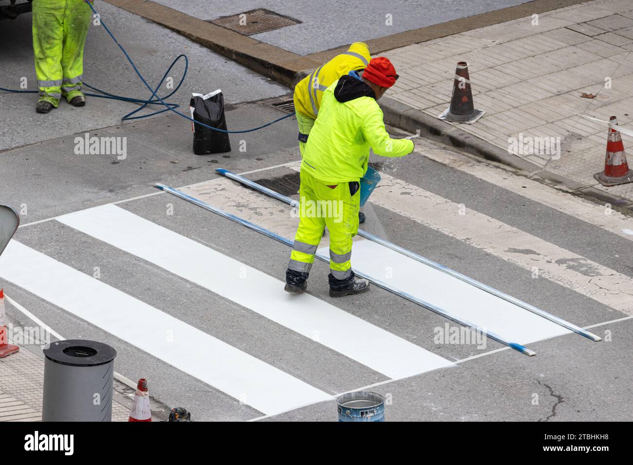 Roadwork Workers painting a Pedestrian crosswalk on city. Road ...