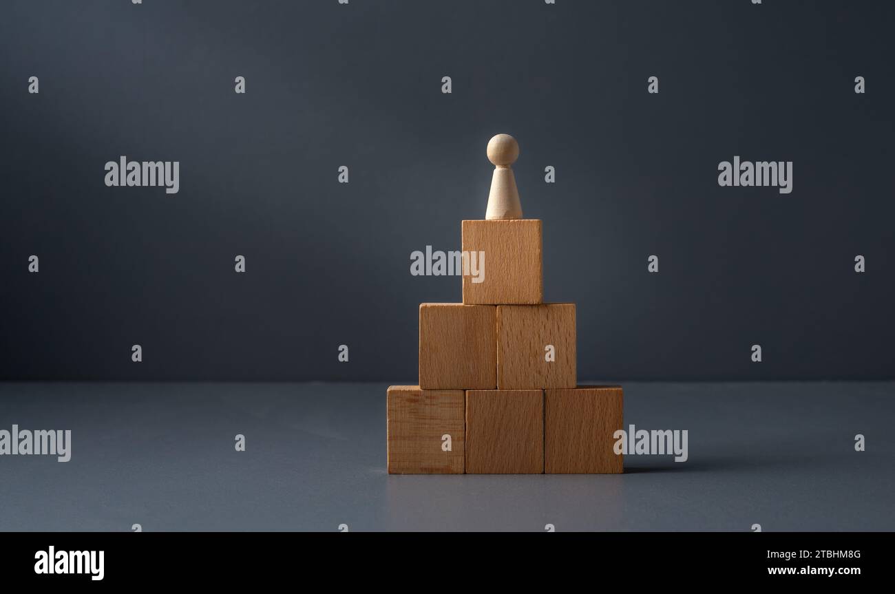 concept of being a winner ,wooden figure standing ontop of blocks ...