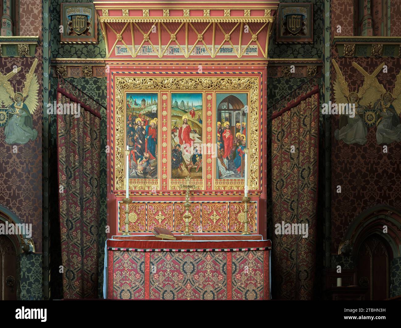 Reredos with tryptich paintings of Jesus Christ behind the altar in the ...