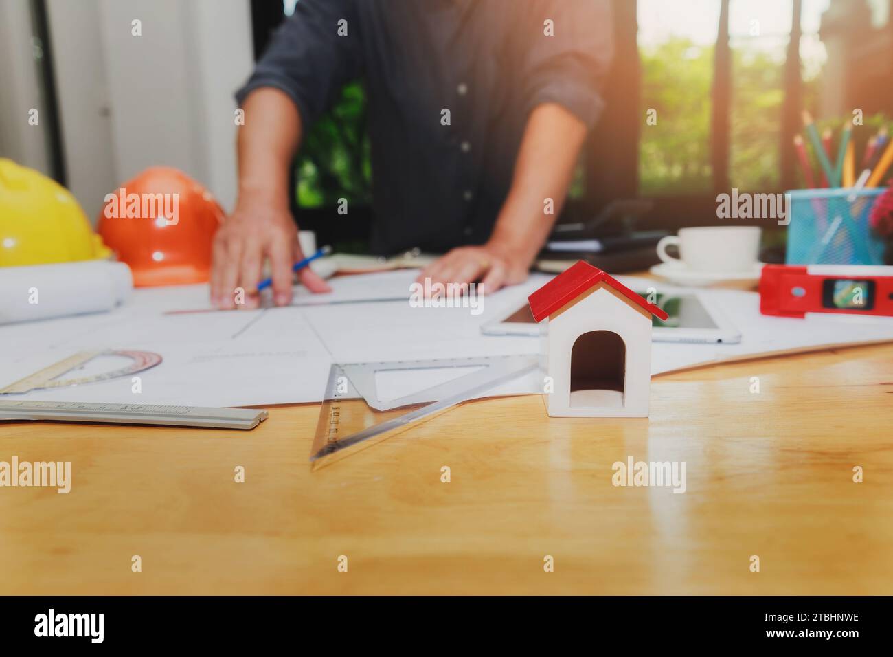 Close up of a house model on the desk with architect working with ...