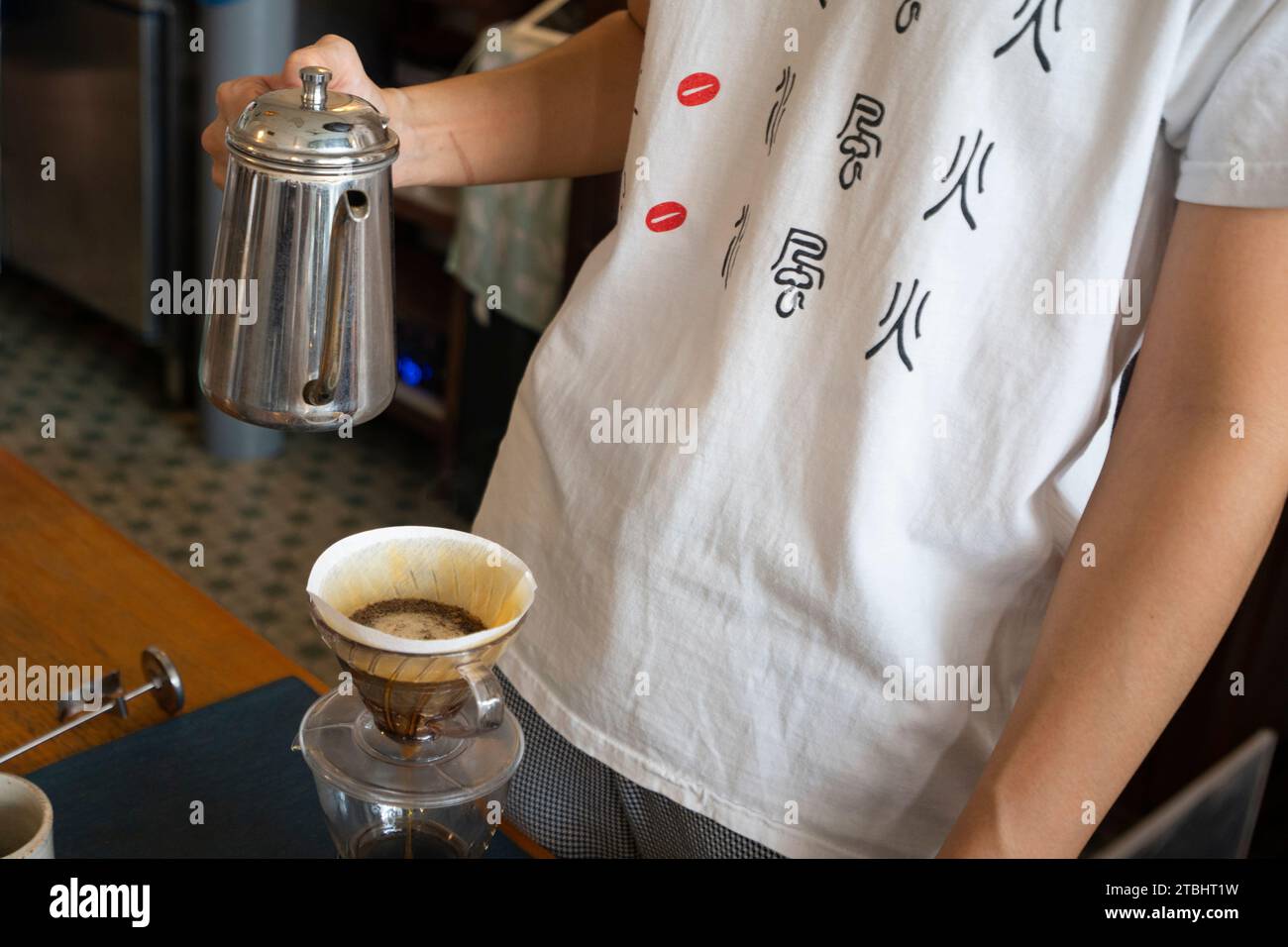 Barista brewing coffee in a cafe. Close-up of barista making drip ...