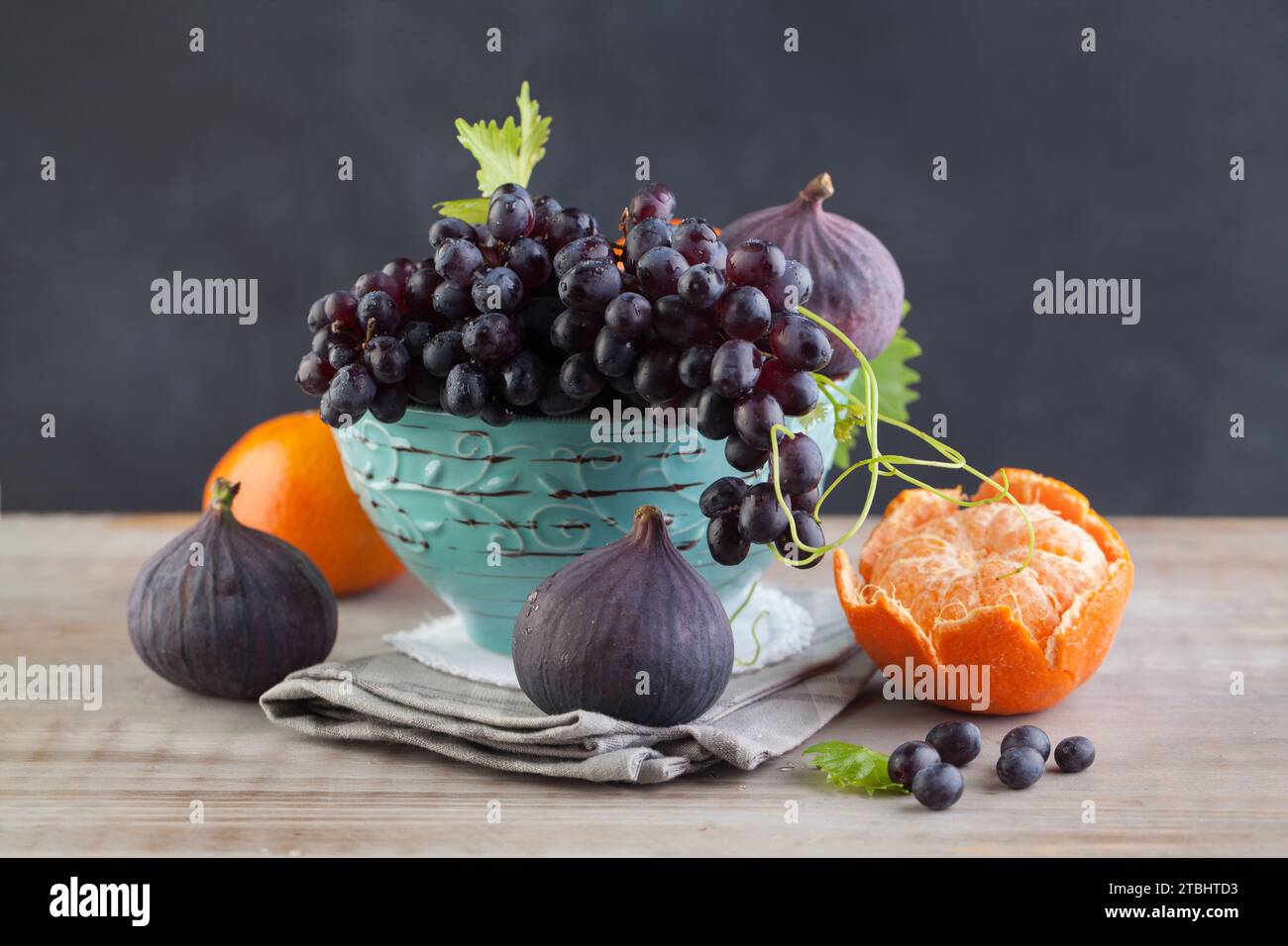 Variety fruit orange tangerine, figs and grape with green leaves ...