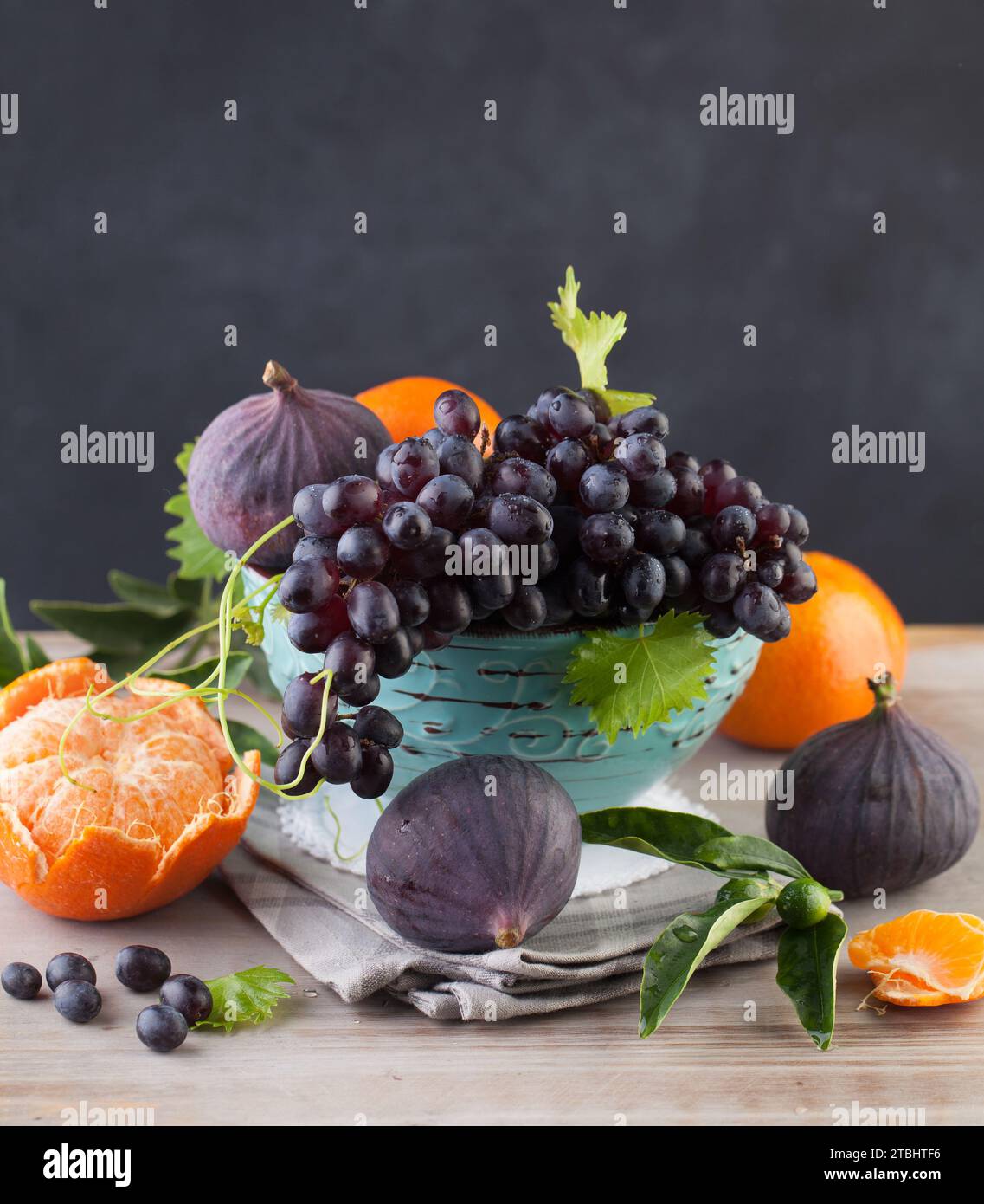Testy orange tangerine, figs and grape fruit mix with green leaves ...