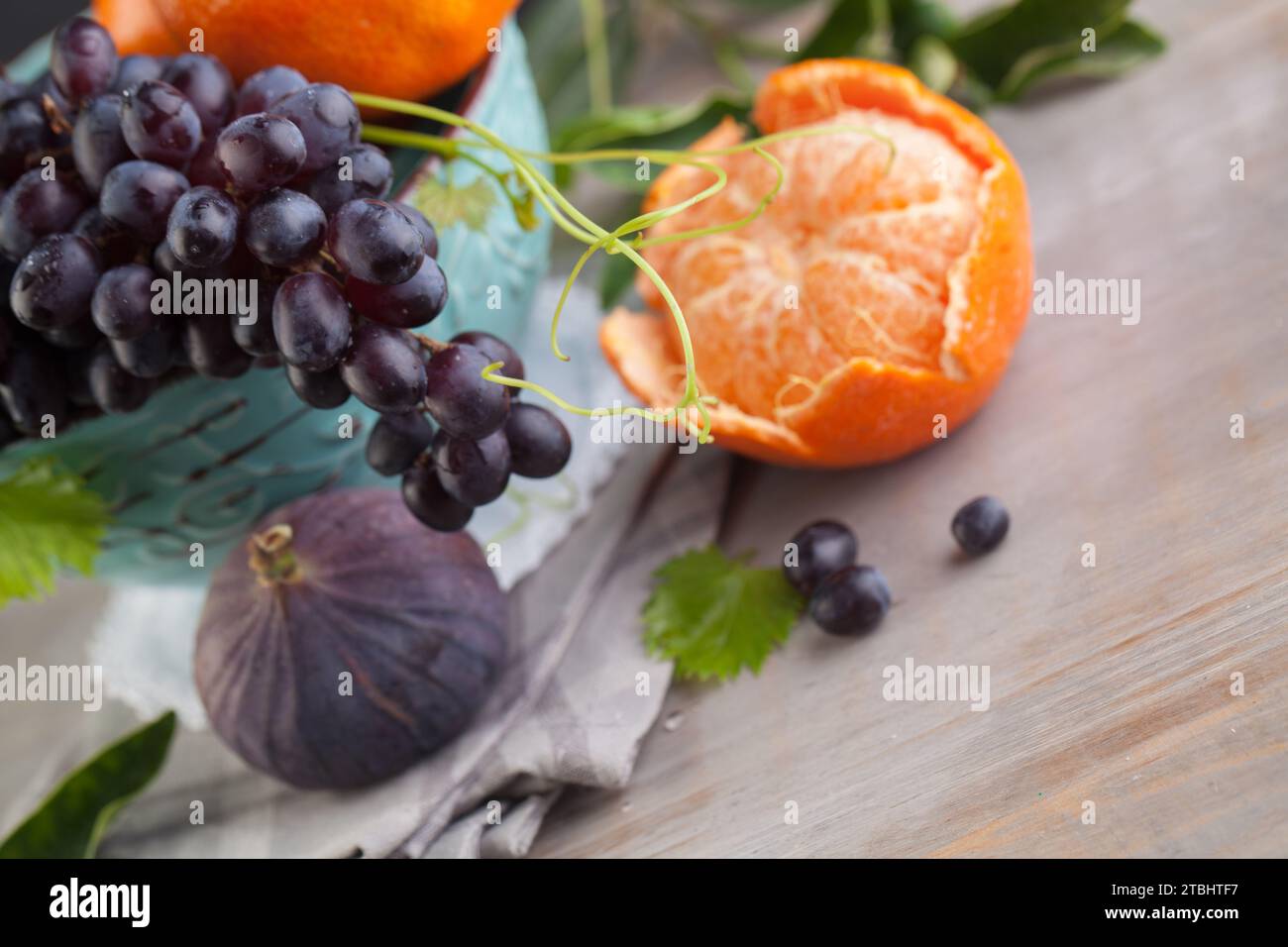 Blue grape, orange tangerine, figs fruit mix, healthy food background ...