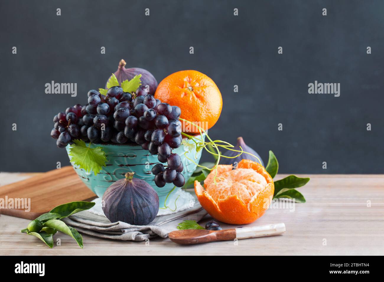 Organic orange tangerine, figs and grape fruit mix with green leaves ...