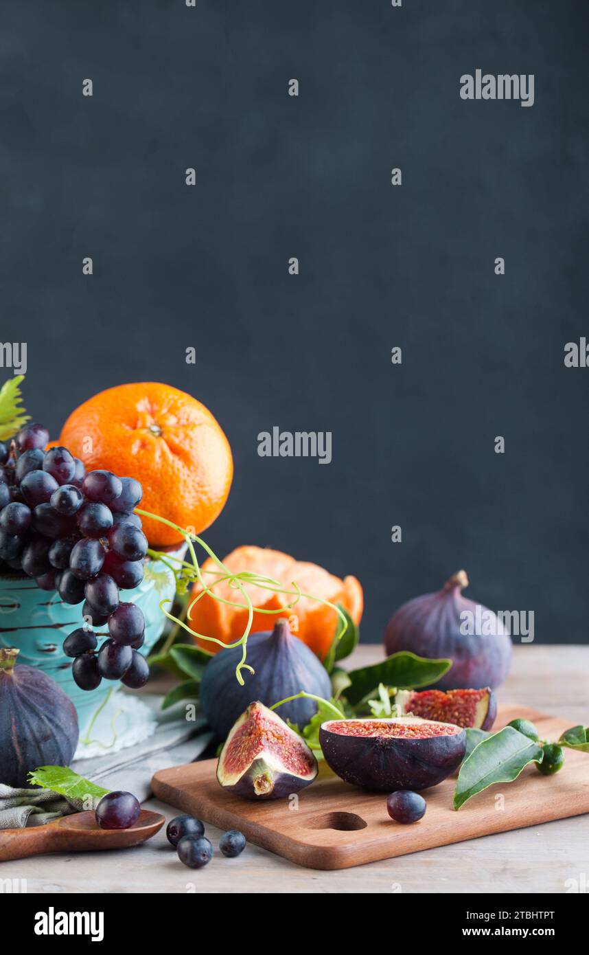 Raw orange tangerine, figs and grape fruit mix with green leaves ...