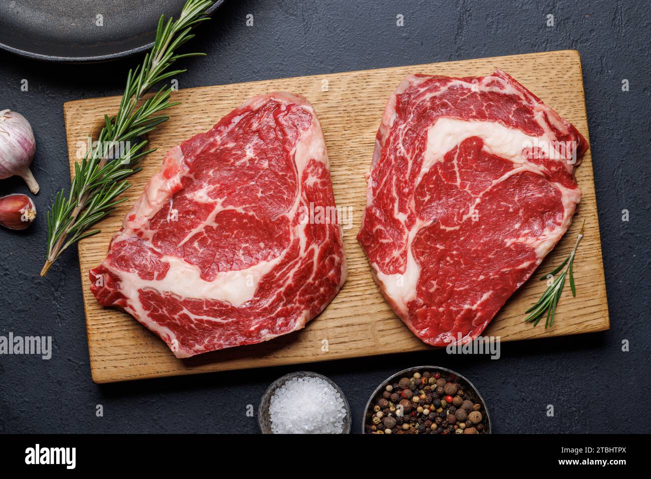 Raw ribeye steaks with savory spices. Flat lay Stock Photo - Alamy