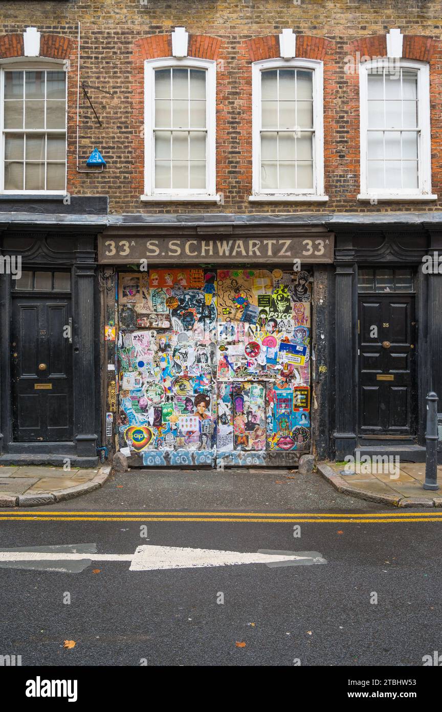 Fly posters and graffiti on yard entry doors to S. Schwartz, possibly a ...
