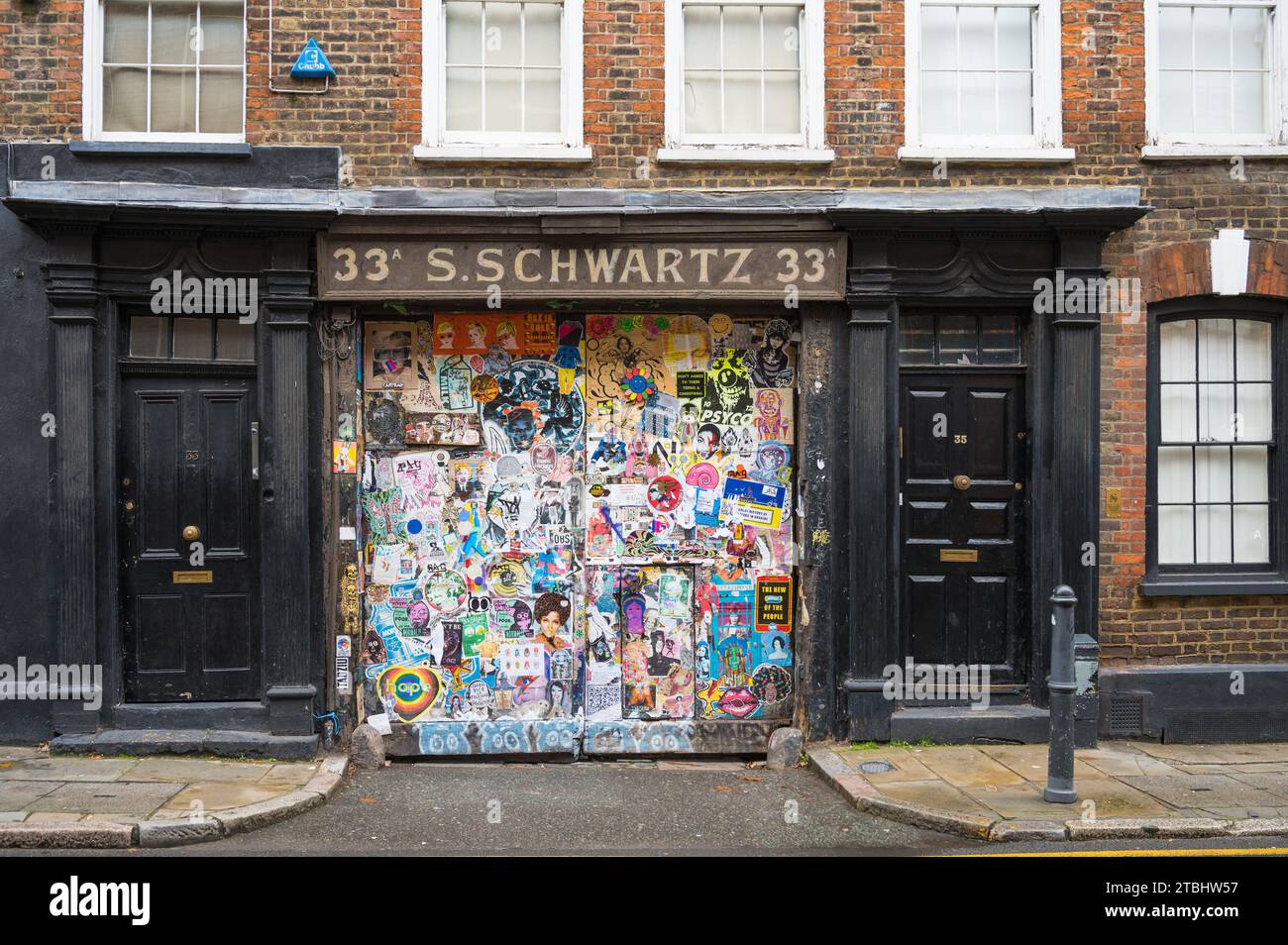 Fly posters and graffiti on yard entry doors to S. Schwartz, possibly a ...