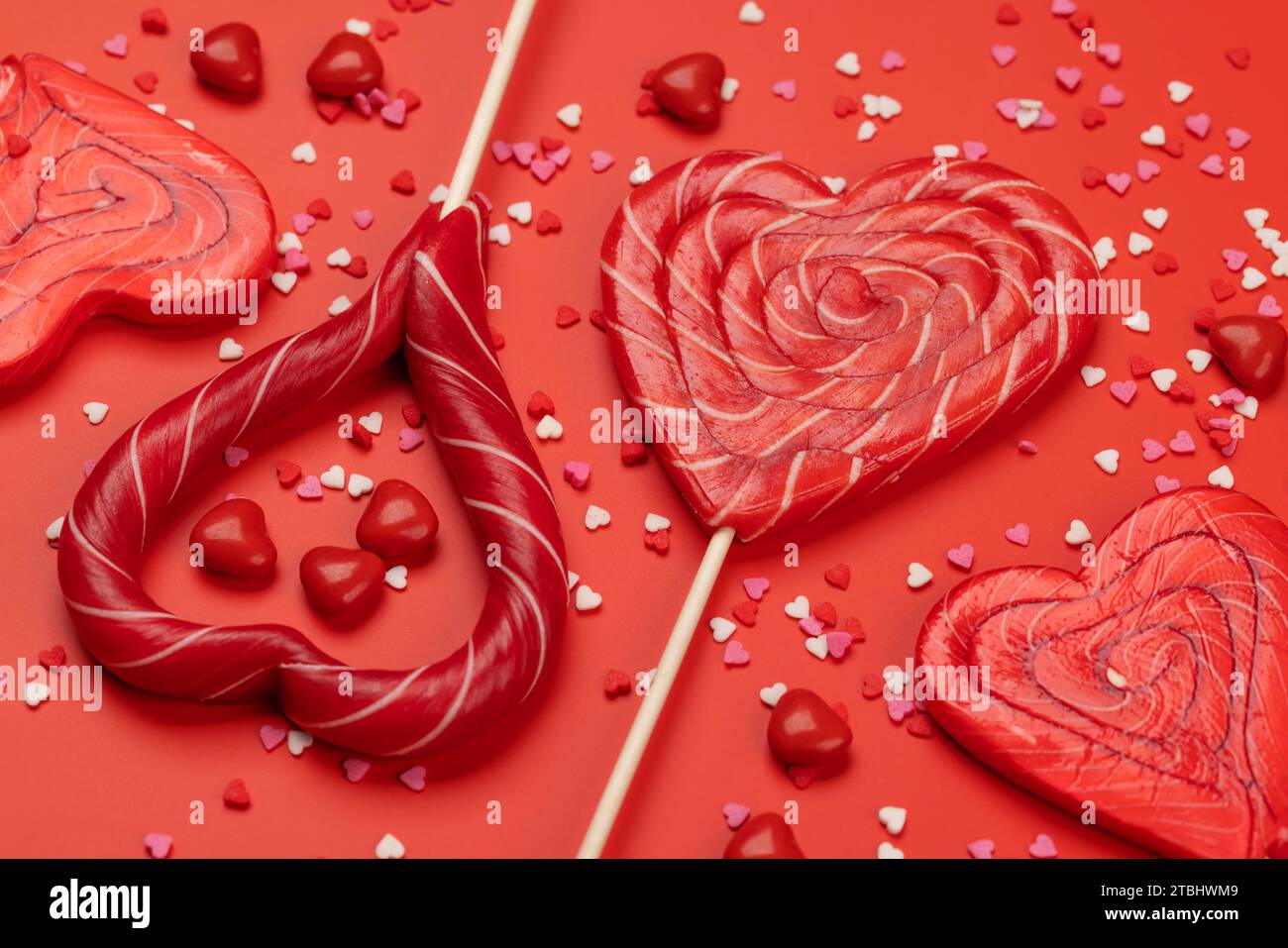 Various red candy sweets lollipops on red background. Valentines day ...