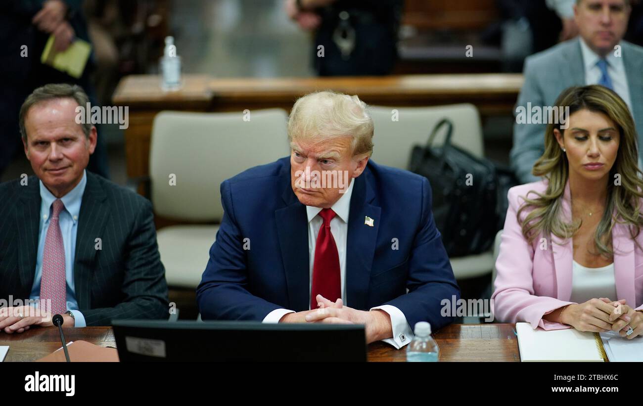 Former President Donald Trump, center, sits at the defense table with ...
