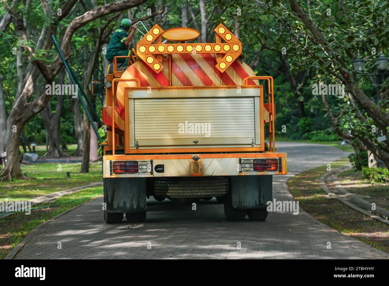 Cleaning truck with indicator lights and arrows in a city park Stock ...